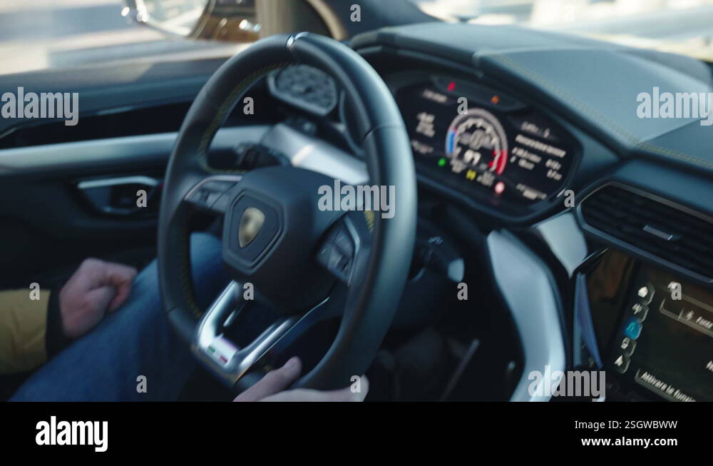 Driver steering wheel of sport car, man driving inside super sport car ...