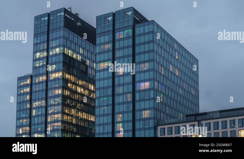 Day to night office windows glass business building downtown rainy ...
