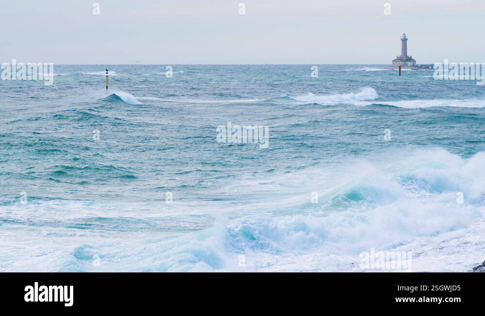 Lighthouse Porer and carinal markunder strong waves on stormy weather ...