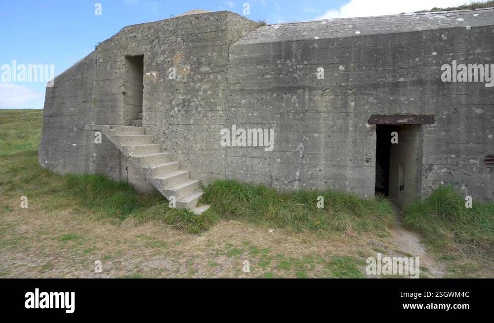 Panning view of entrances to WW2 Bunker ruins on Utah Beach, Normandy ...