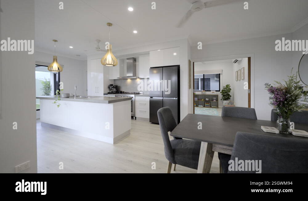 Contemporary open plan living room, dining room, and kitchen. White ...
