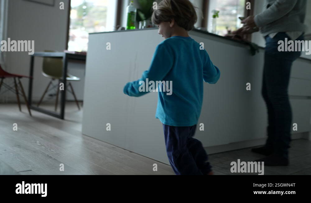 One happy child running at home interior. Back of small excited boy ...