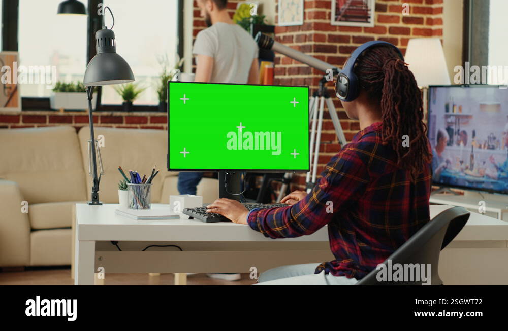 African american person working with greenscreen and listening to music ...