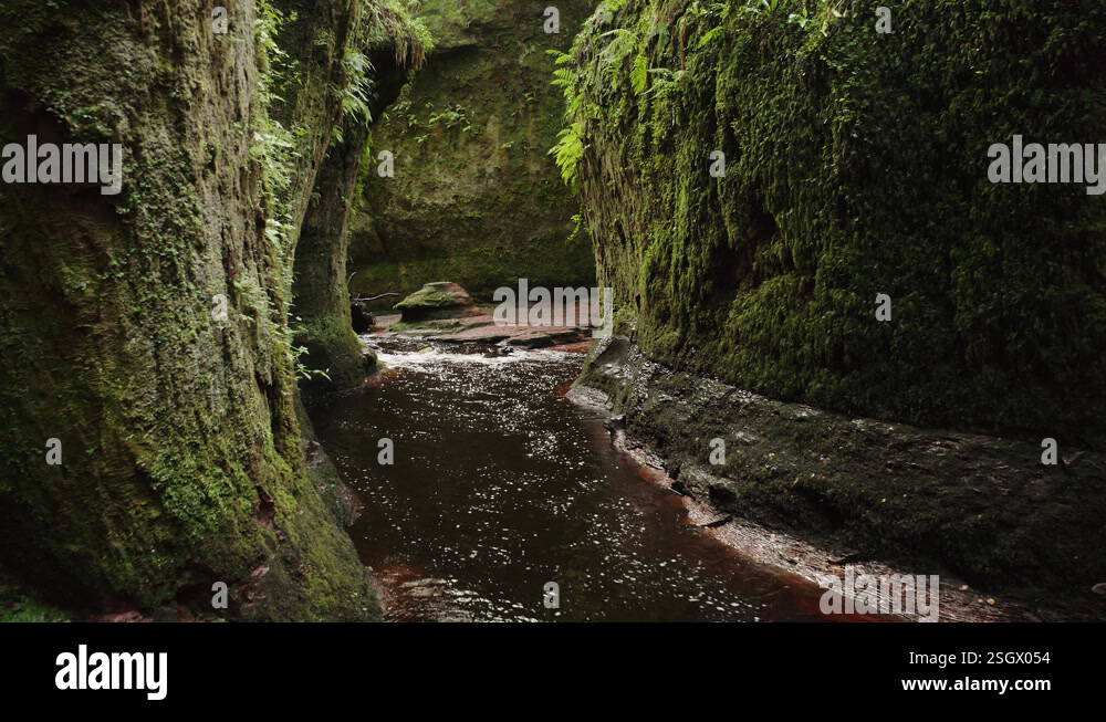 Drone shot creeping through the Devils Pulpit gorge in Scotland ...
