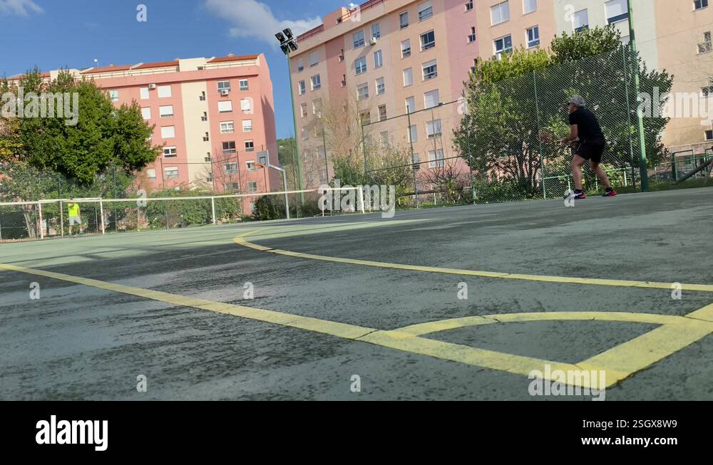 Professional equipped male tennis players beating hard the tennis ball ...