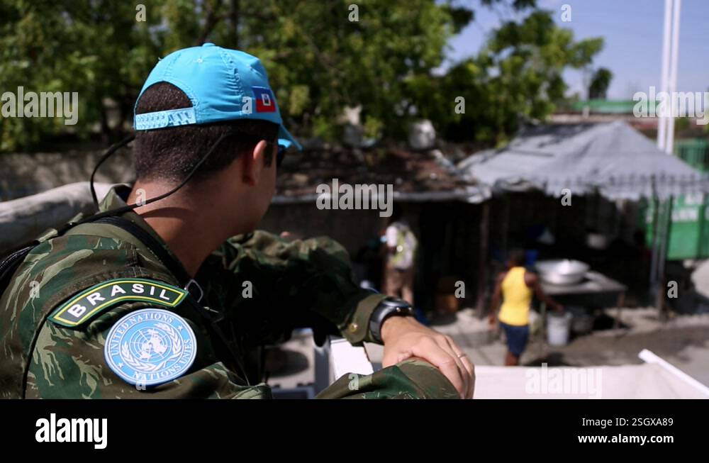UN peacekeeper soldiers in uniform standing on back of military vehicle ...