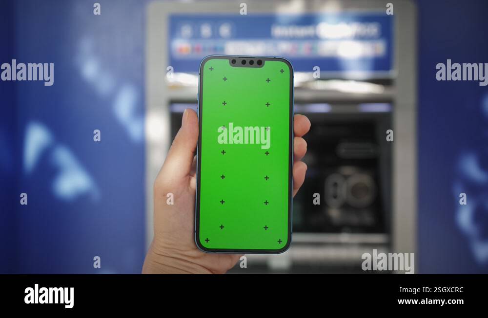 Withdraw money from an ATM, holding phone with green screen, using app mobile Stock Video ...