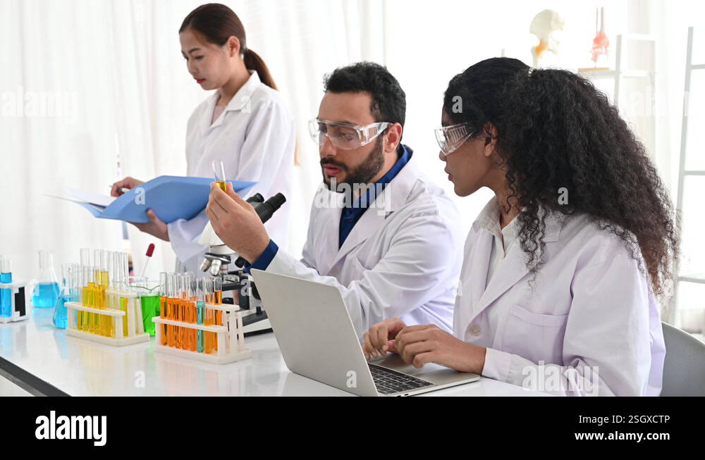 4K Group of laboratory scientists working at lab with test tubes Stock ...