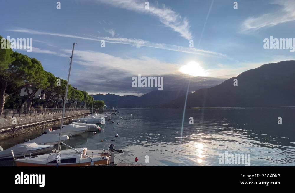 Lake view and a little pretty pier with sailing and classic boats Stock ...