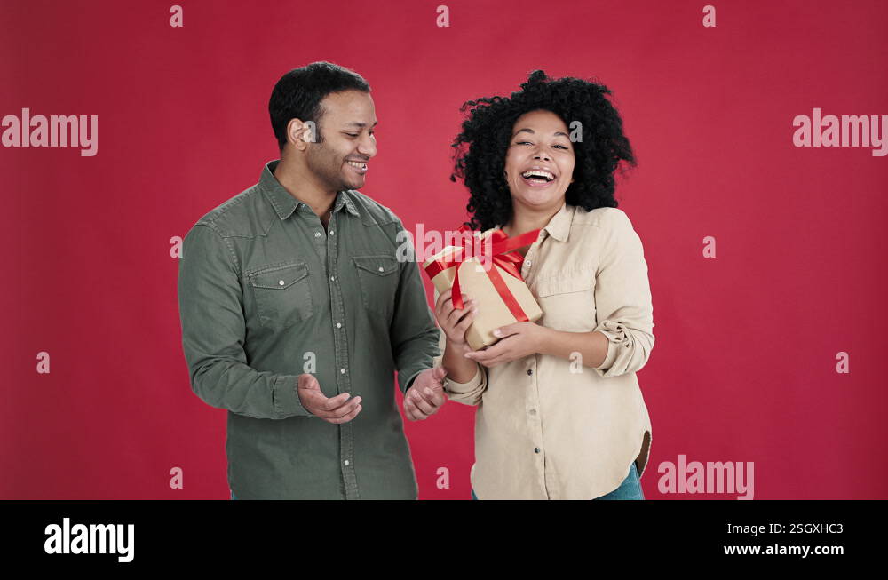 Indian man and African American woman catch gift box happily Stock ...