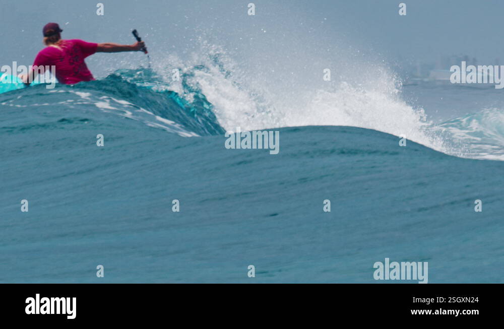 MALE, MALDIVES - NOVEMBER 2022: Beginner surfer disappears in the wave ...
