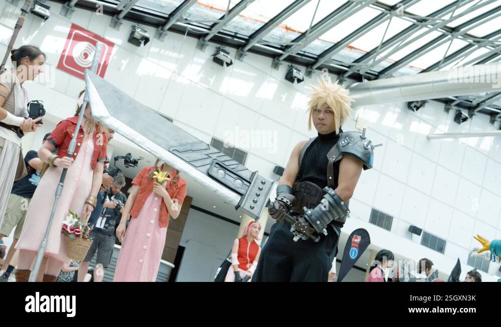 Man in cosplay costume with a big sword slash in front of the camera ...