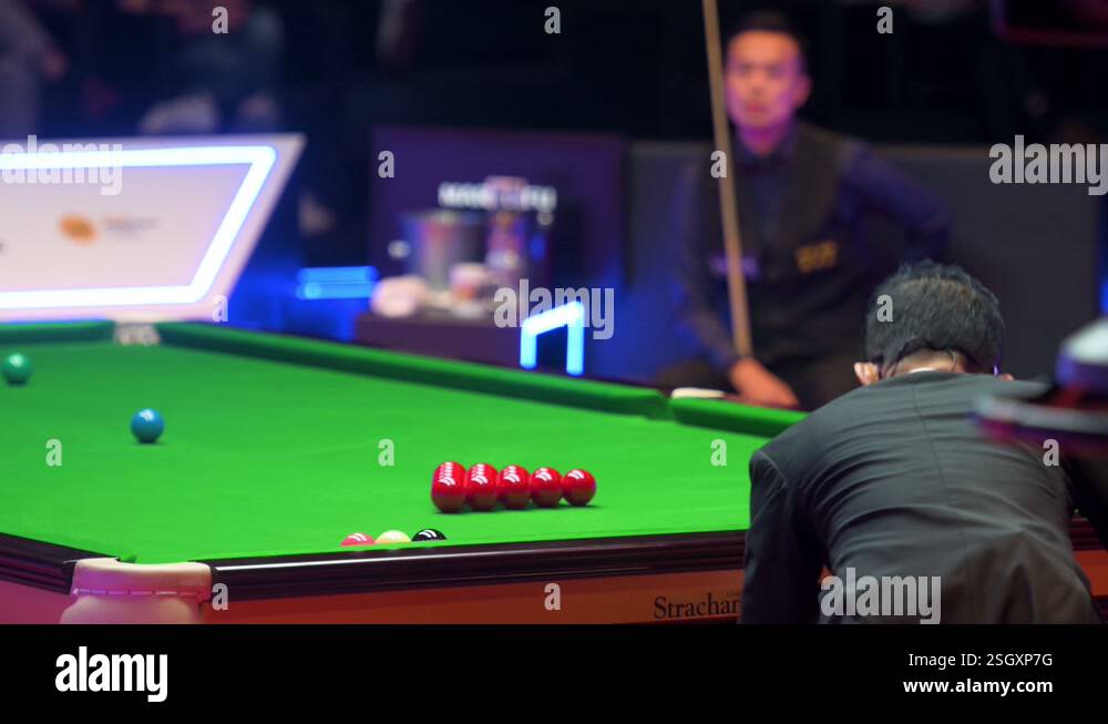 A referee adjusts the balls to start a new set as a professional ...