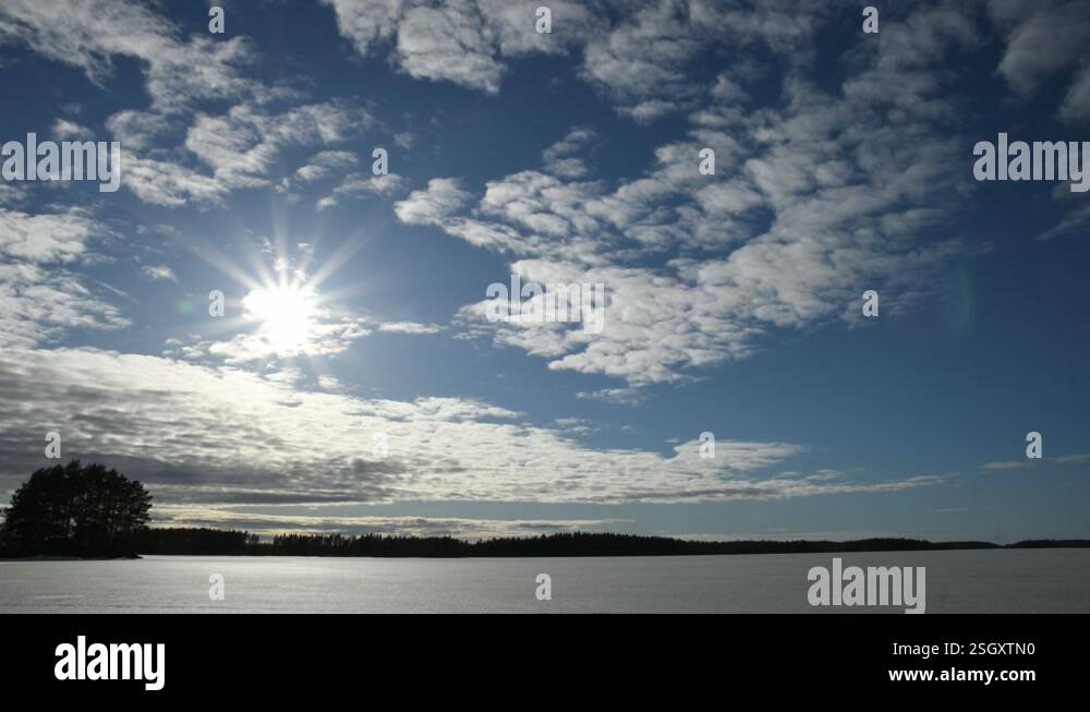 Time lapse of sky clearing from clouds on a beautiful winter day. Sun ...