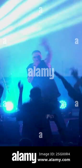 Vertical, A rock pop band is playing on stage. Listeners raised their ...