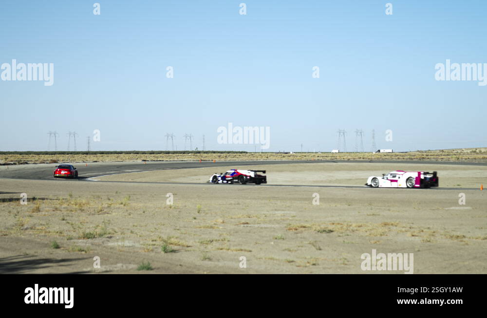 Race cars taking turn on a curved race track Stock Video Footage - Alamy