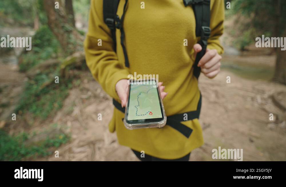 Woman hiking and backpack walking and using smartphone lookig GPS in the forest Stock Video ...