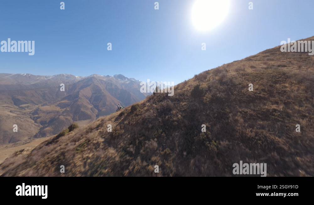 Extreme speed race mountain motorbike sports man riding up slope to ...