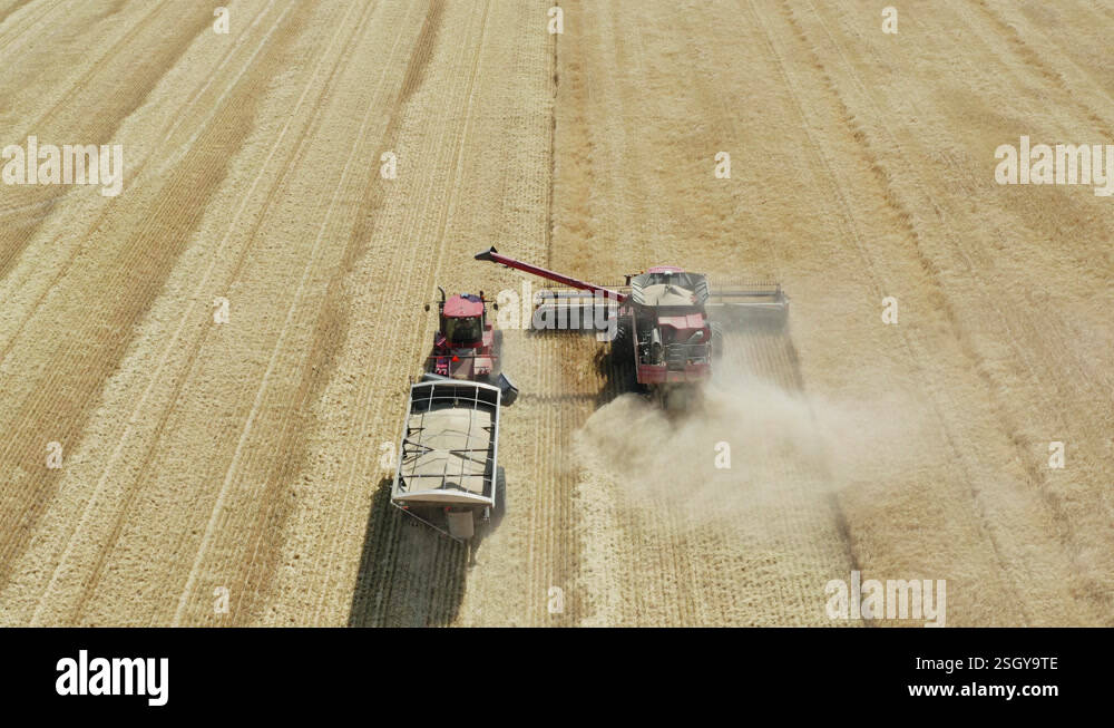Combine harvester unloading tractor Stock Videos & Footage - HD and 4K ...