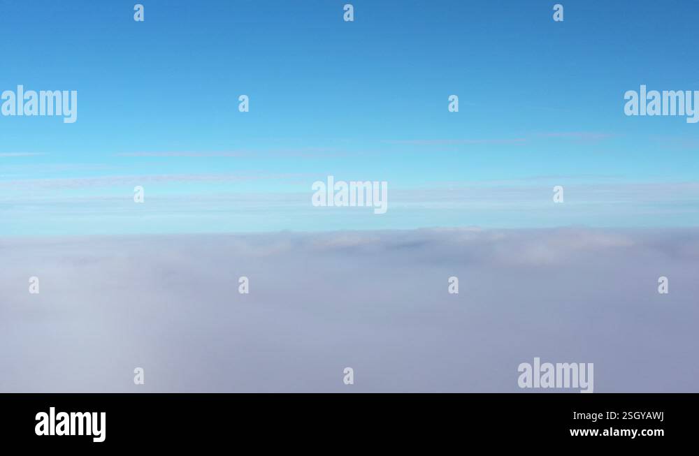 Blue sky background above mist, gradiently turning into a fog ...