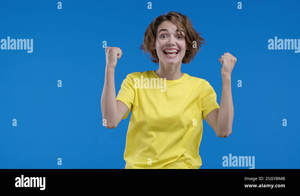 Pretty woman shows triumph yes gesture of victory, she achieved result ...