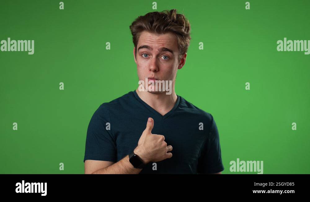 Confused young man 20s posing isolated on green screen background in ...