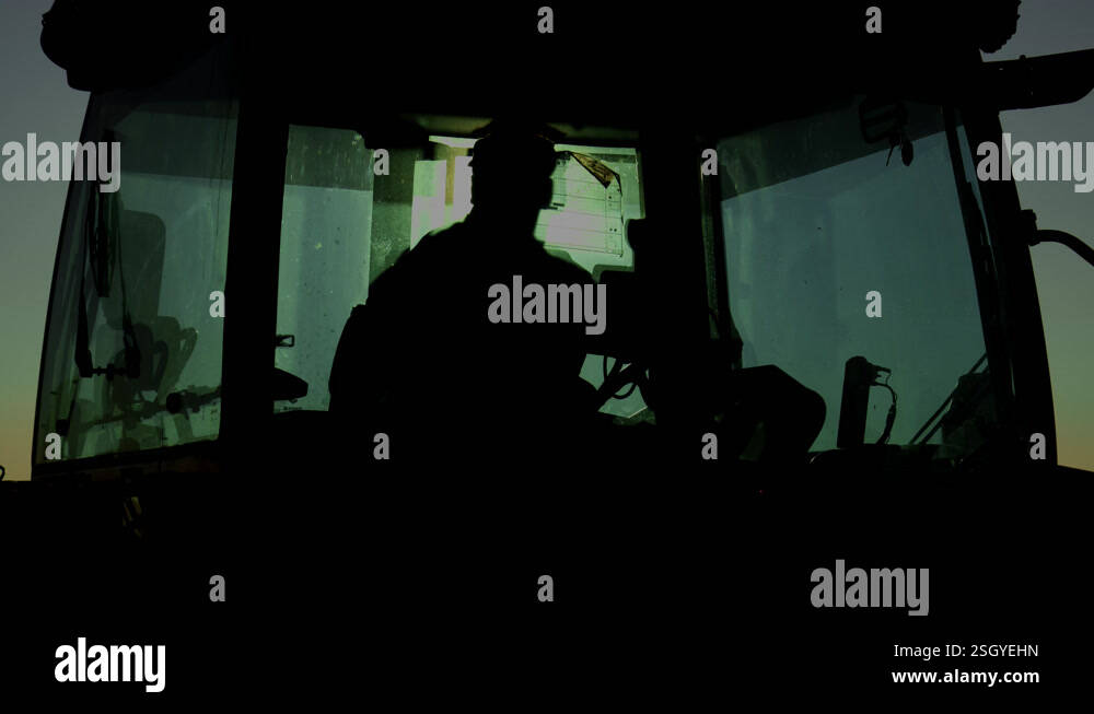 unrecognizable farming tractor driver turns behind wheel and is about ...