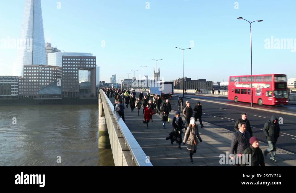 commuters cross London bridge for the city of London Stock Video ...