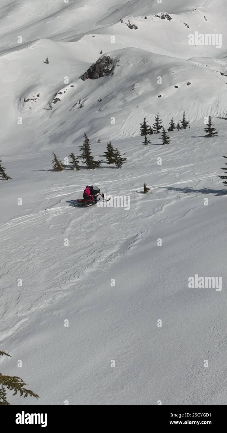 Vertical Video Snowmobile high in the mountains aerial view Stock Video ...