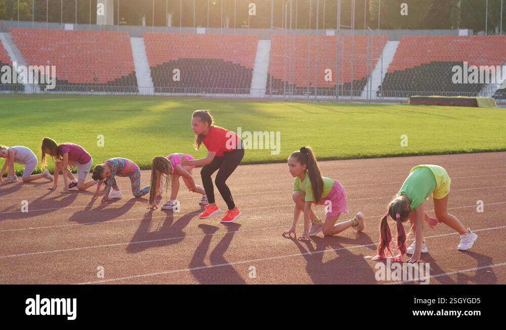 A group of children running on a treadmill at the stadium on a bright ...