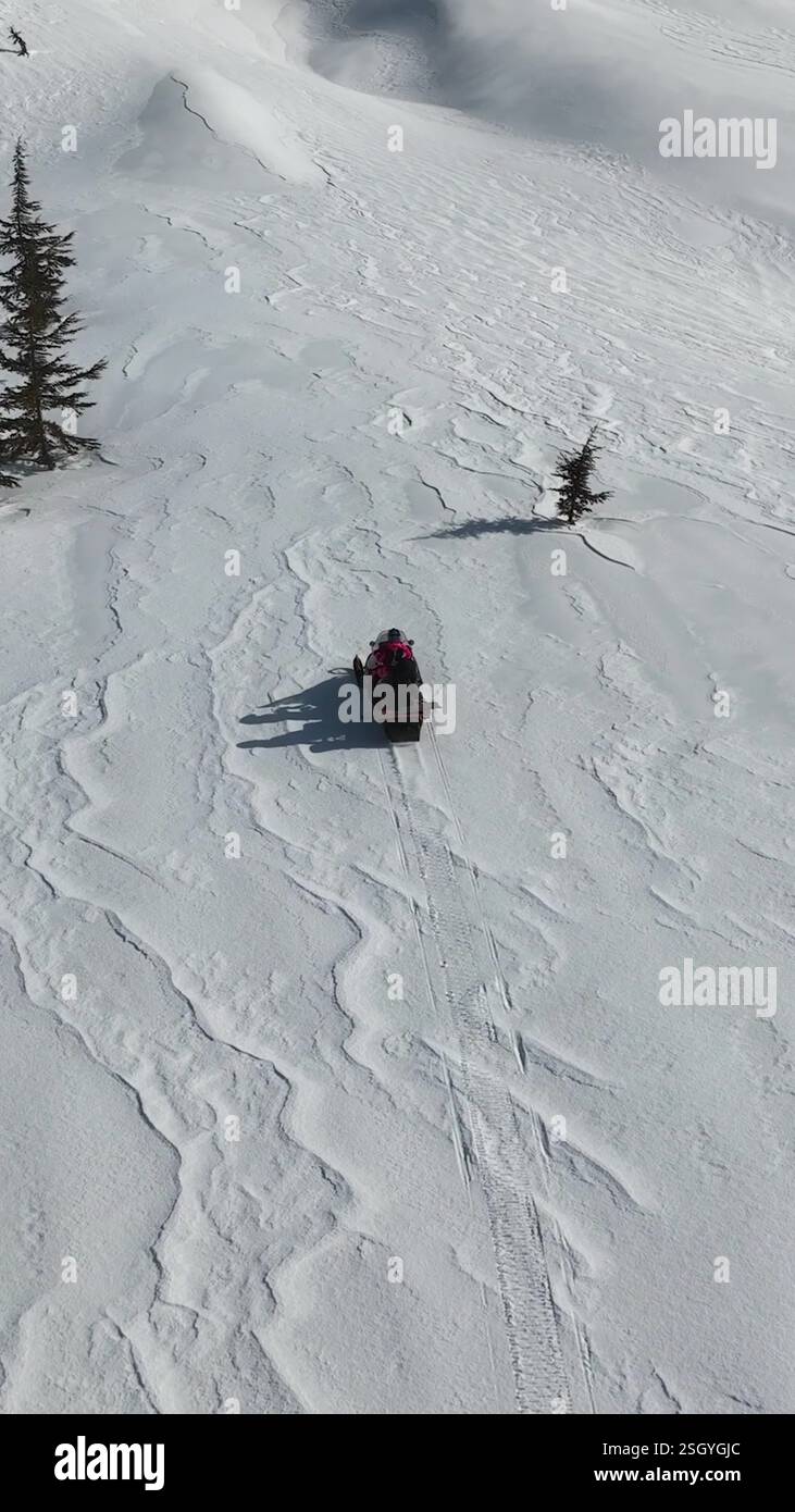 Vertical Video Snowmobile high in the mountains aerial view Stock Video ...