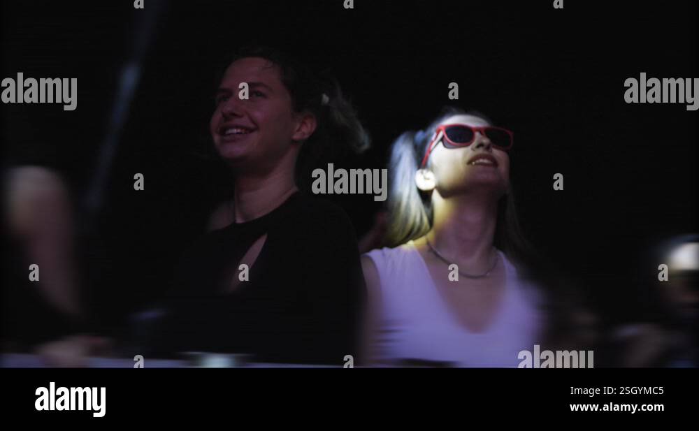 girls dancing in crowd in front of stage with flashing lights Stock ...