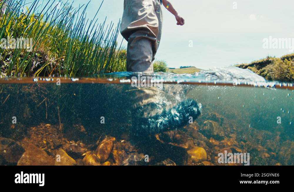 Fisherman underwater view. Angler walks in the wading boots on the ...