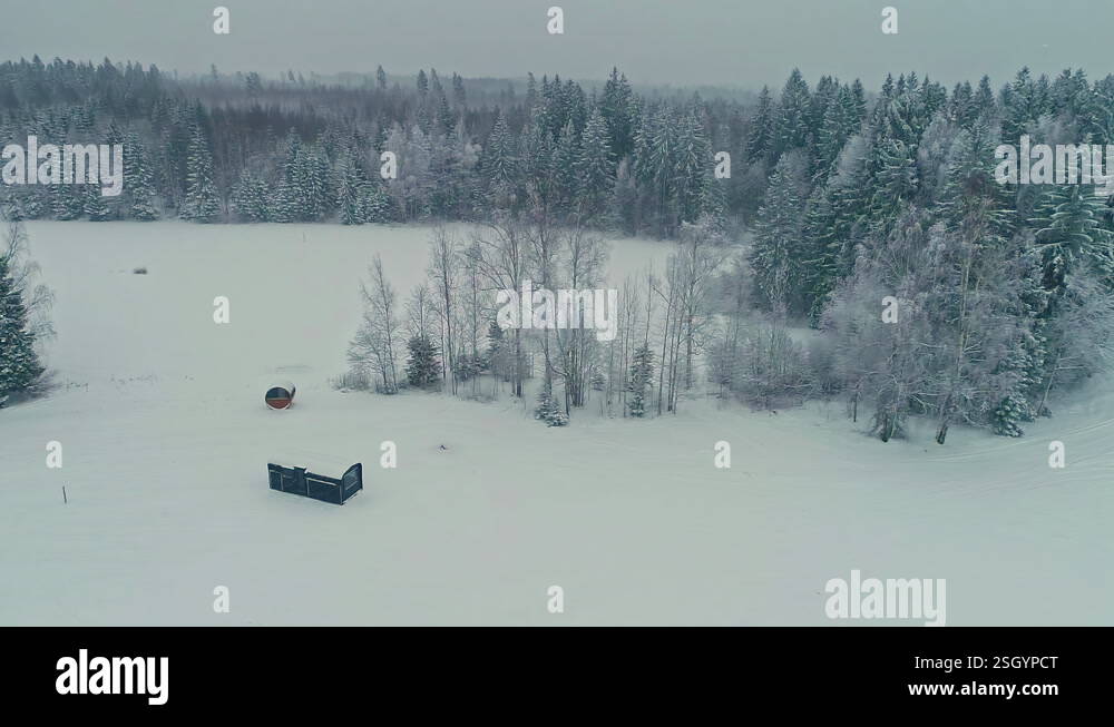 A lonely cabin in a cold, winter meadow in the countryside - push in ...