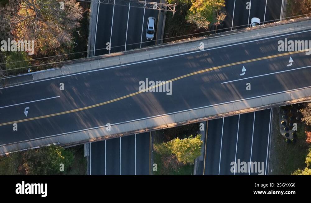 An aerial, top down view over a highway in slow-motion. The camera ...
