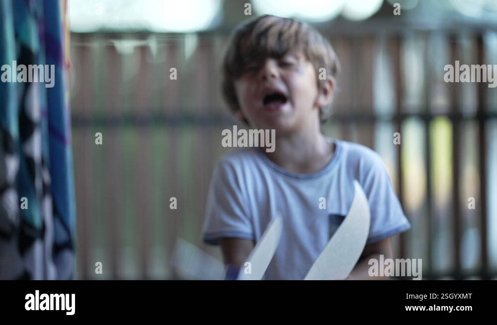 One irritated little boy doing a tantrum while holding airplane toy in ...