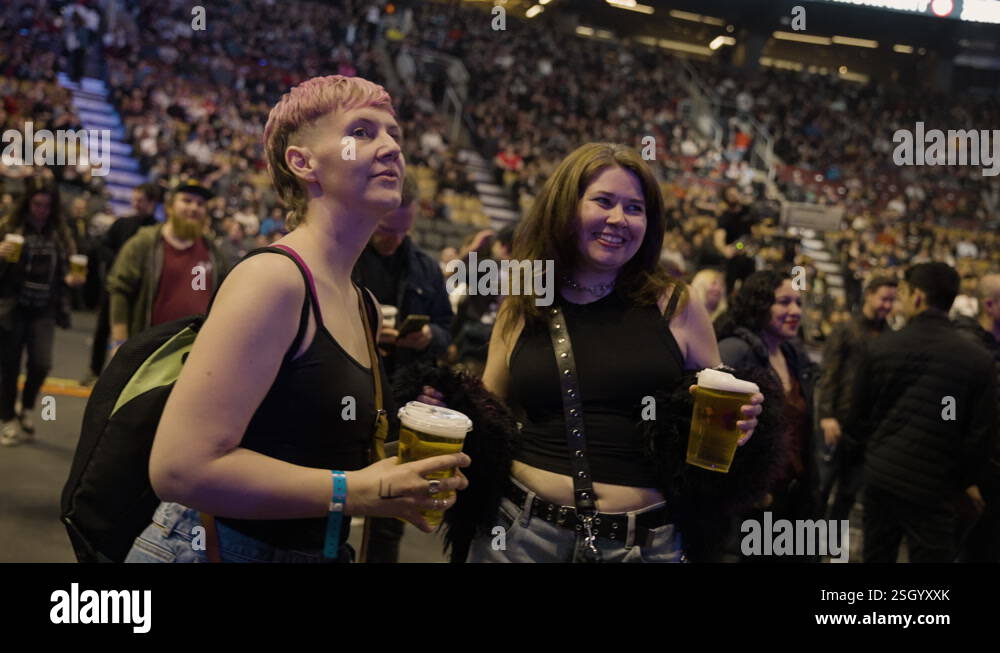 Two Young Ladies Friends Spectators Standing Dancing Holding Beer Cups ...