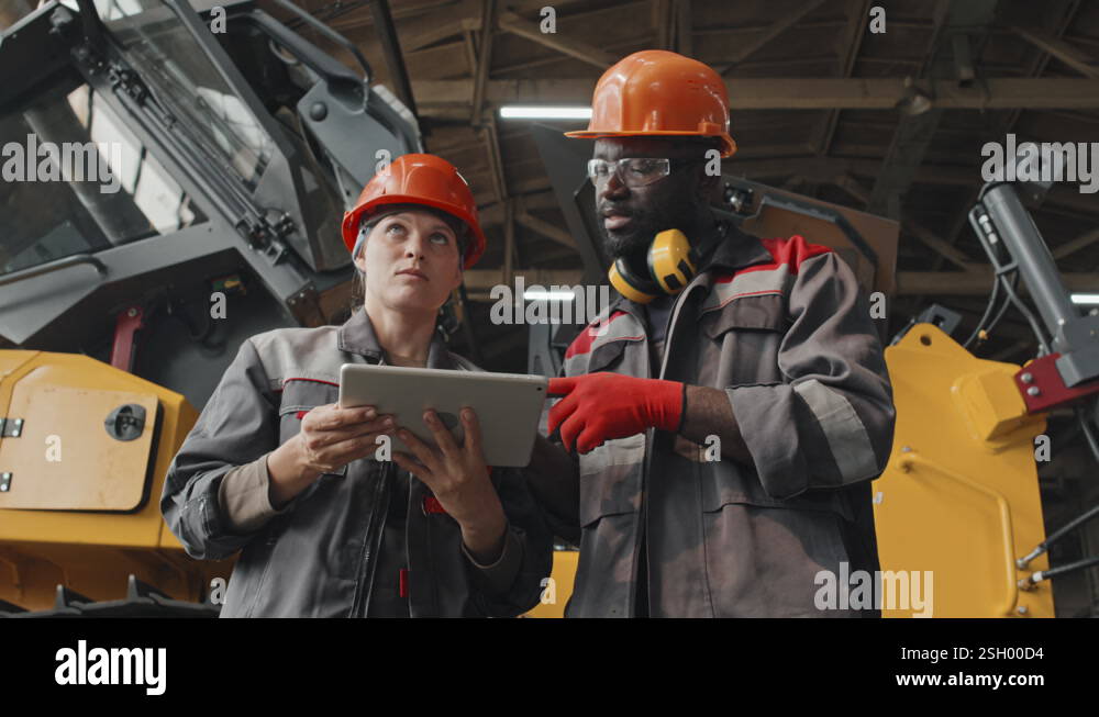 Industrial Engineers Working at Tractor Plant Stock Video Footage - Alamy