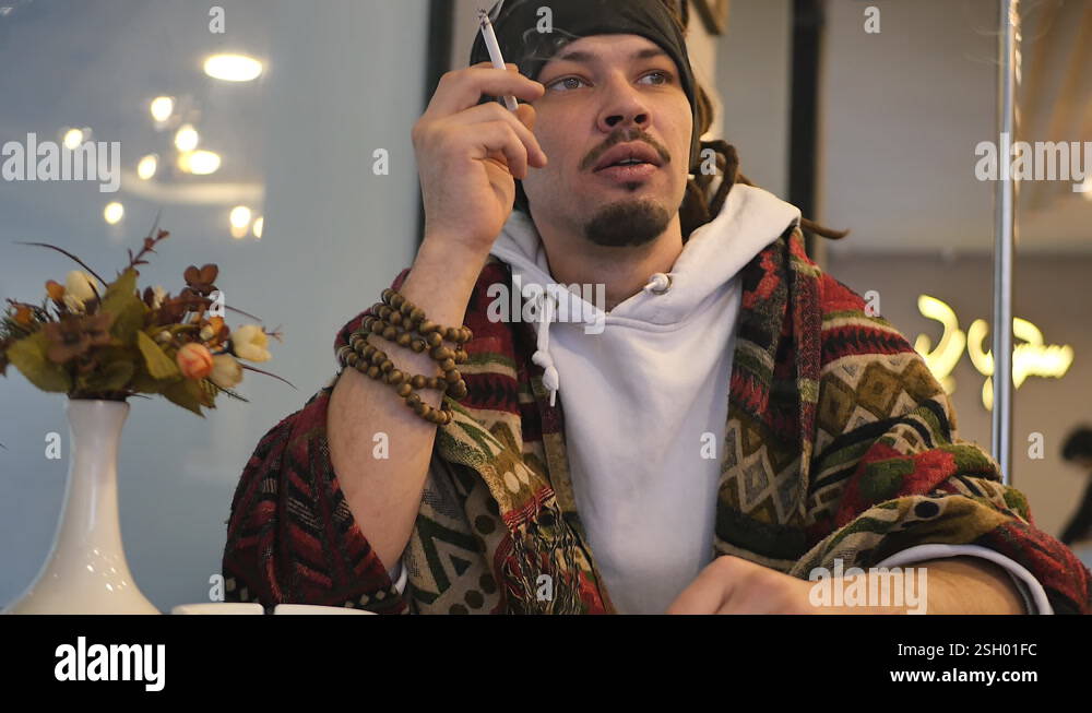 Portrait of an attractive mixed race man with dreadlocks and plaid ...