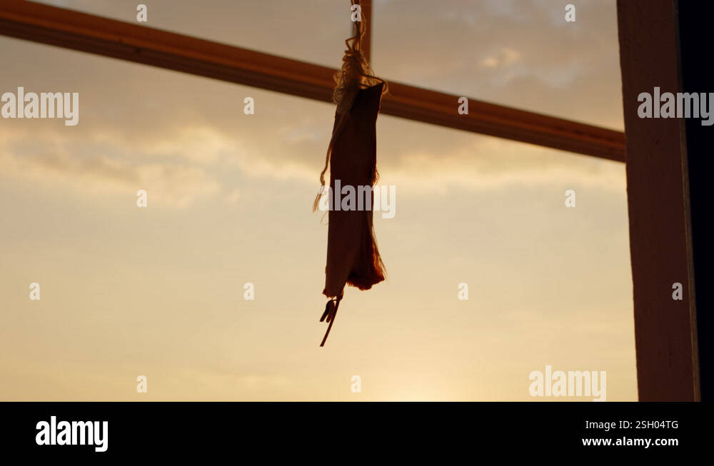 Old Vintage note on rope hang on window, in which in background there ...