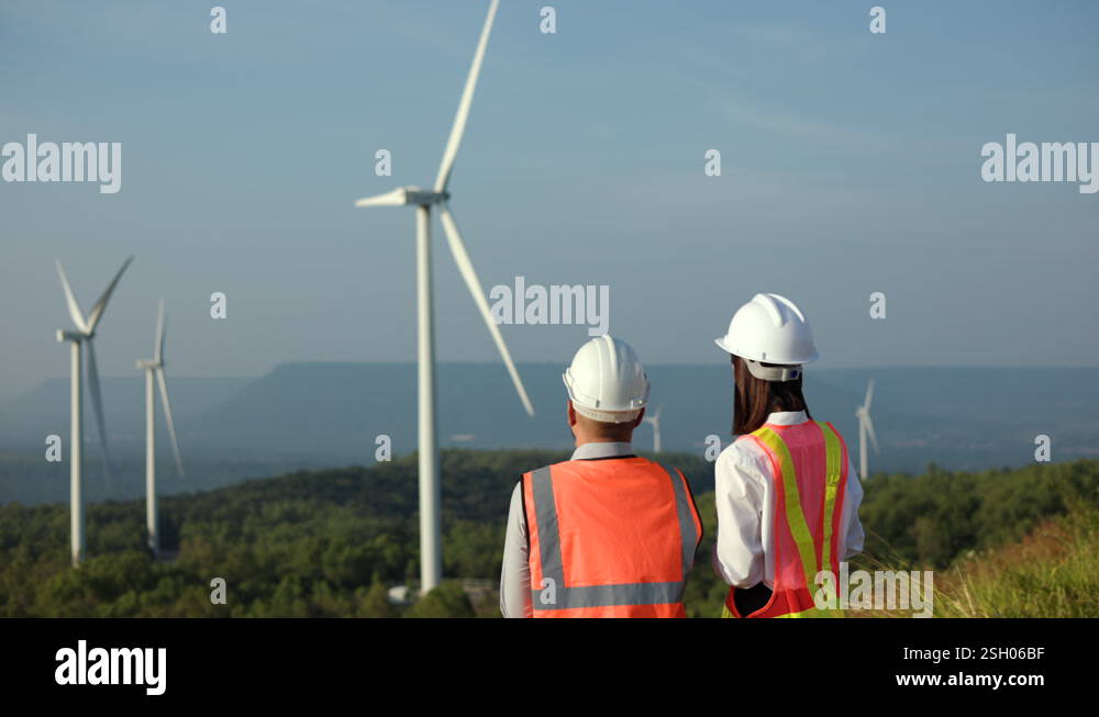 Confident two engineer using tablet control wind turbine windmill ...