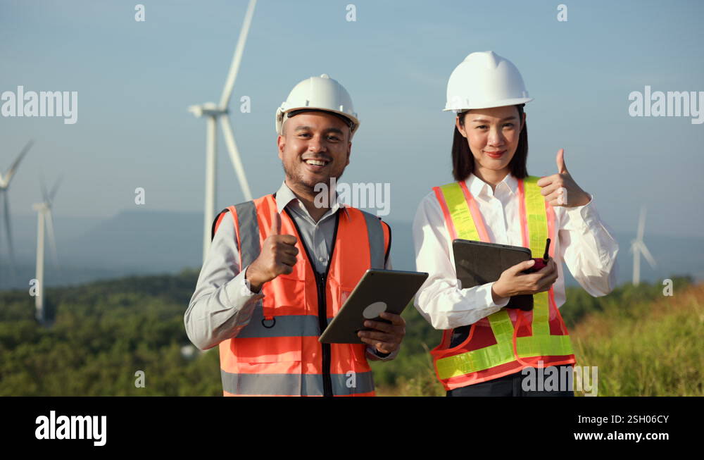 Confident two engineer using tablet control wind turbine windmill ...
