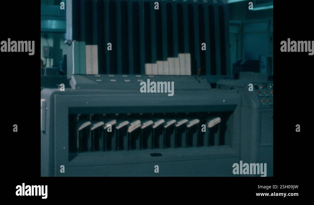 1960s: Index and punch cards drop into slots from card sorting machine ...