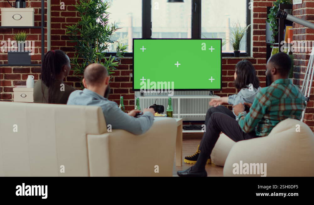 Group of people using greenscreen on tv to play video games Stock Video ...