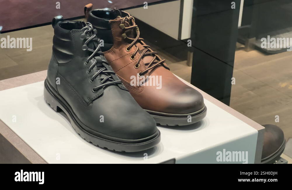 Men's winter high lace-up boots stand in a shoe store window Stock ...