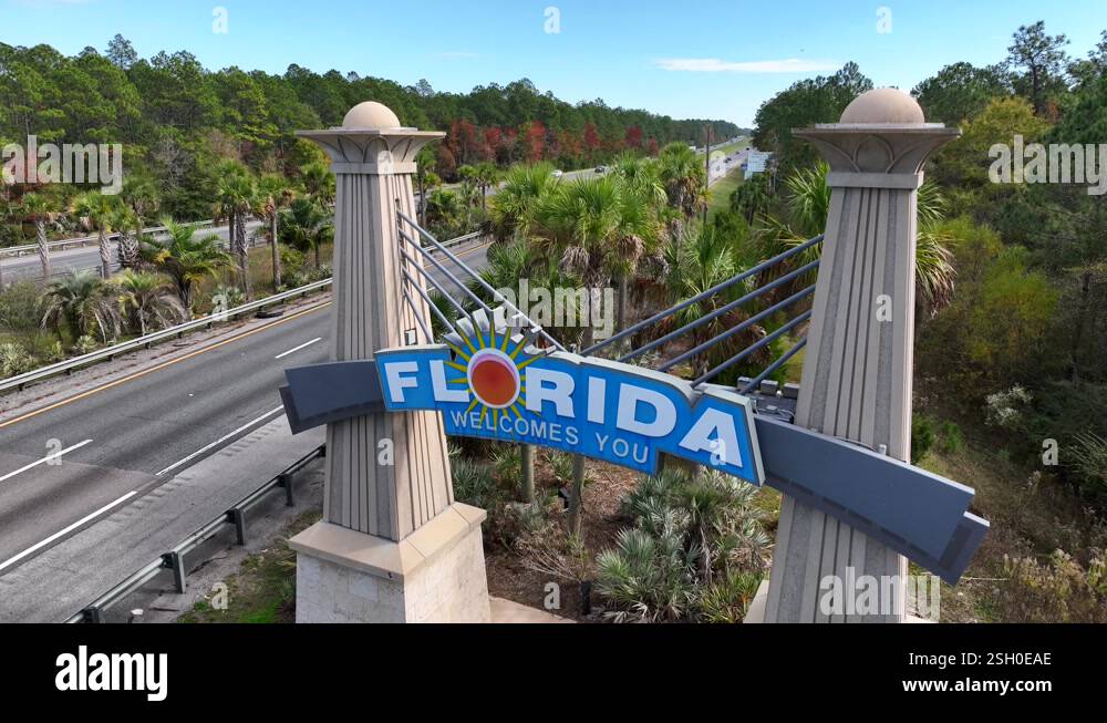 Florida Welcomes You sign along Interstate 10. Rising aerial view at ...