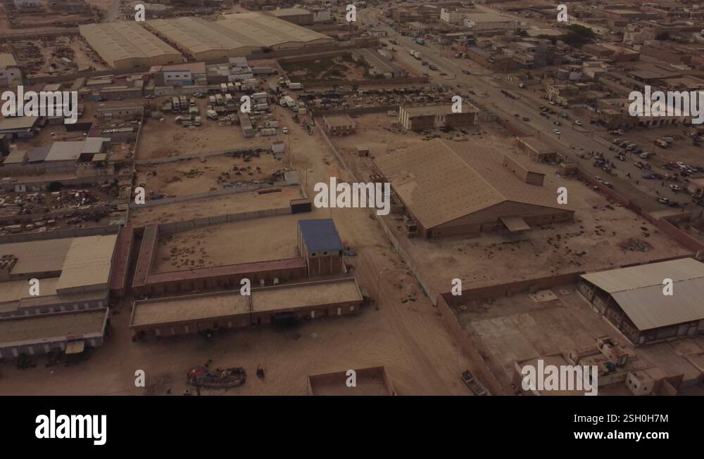 An drone reveal shot moving backwards showing the buildings of the ...