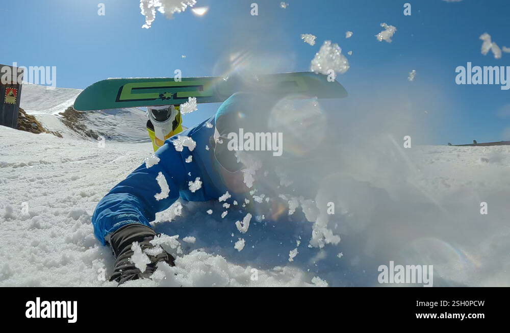 CLOSE UP: Guy trying to make a turn with snowboard when he crashes into ...