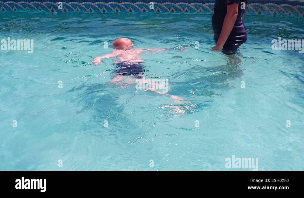 Swimming coach teaches a kid to swim. Child learning to dive in the ...