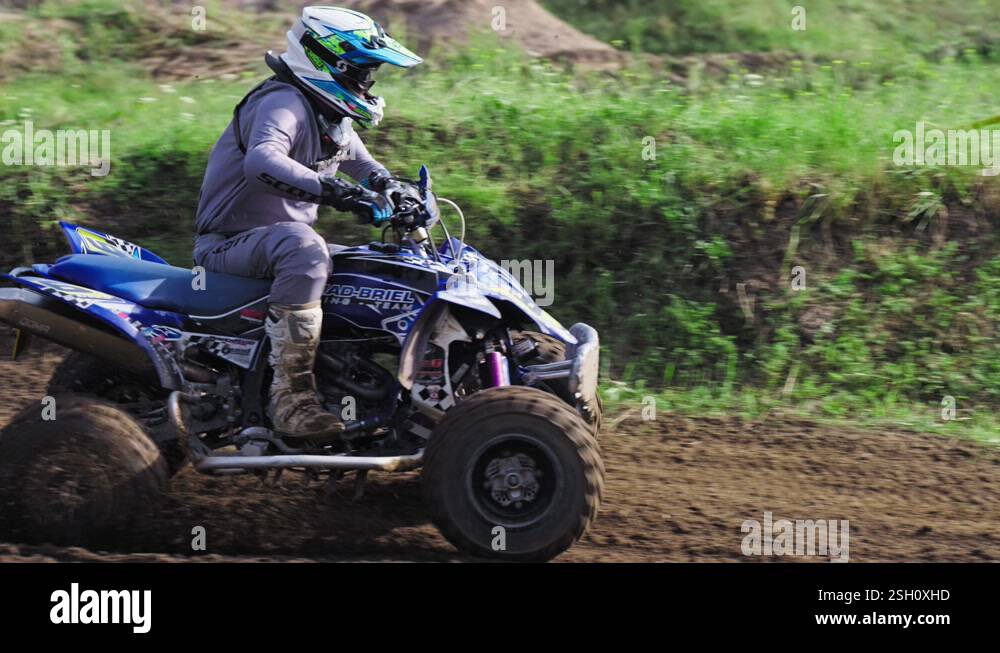 Quad Bike driver leaning into a turn. Tournament riding. Quad Bike PPE ...